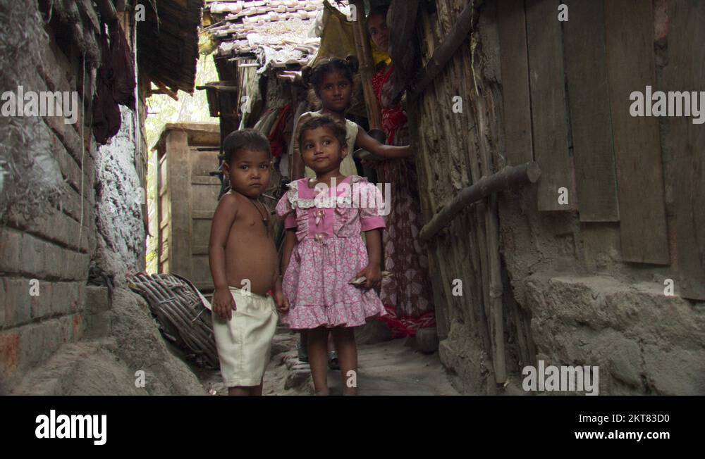 Children in Calcutta alley posing for portrait as mother looks on Stock ...