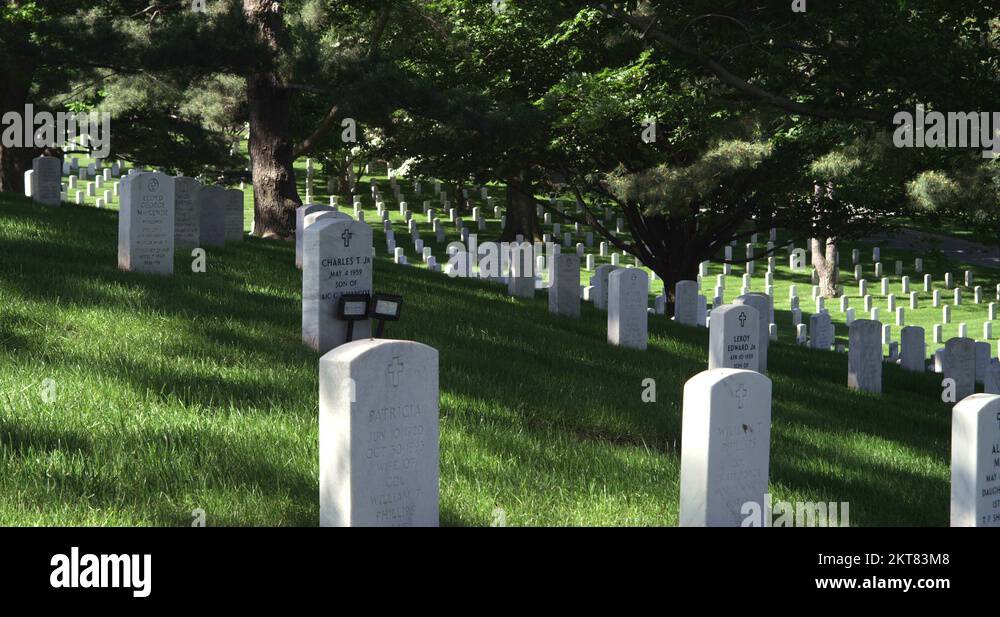 Rows of grave markers on a hillside in Arlington National Cemetery ...