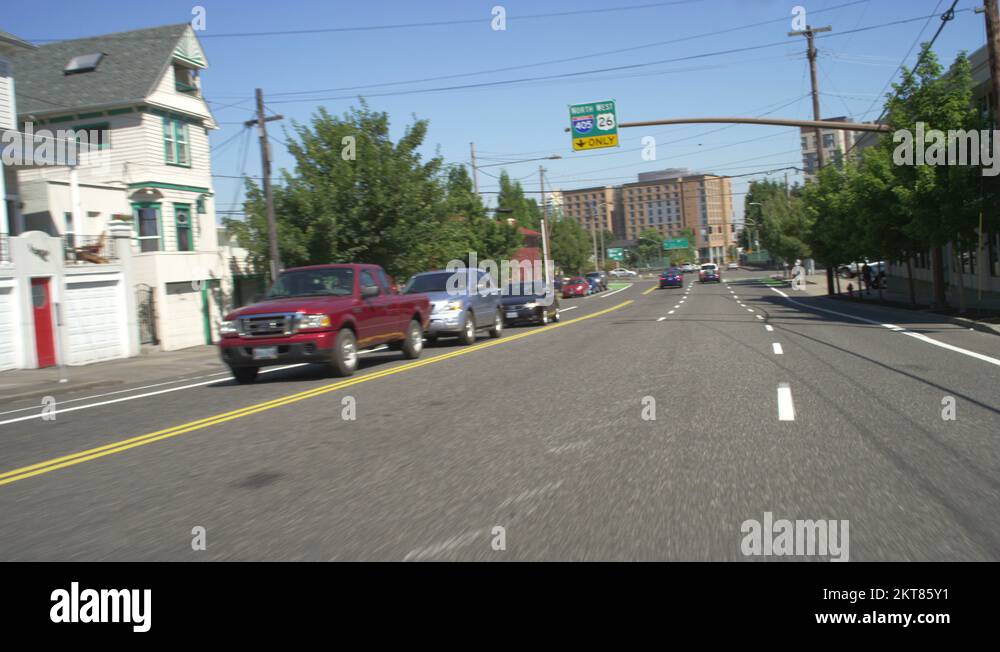 Front view of a Driving Plate: Car is driving down Broadway Street in ...