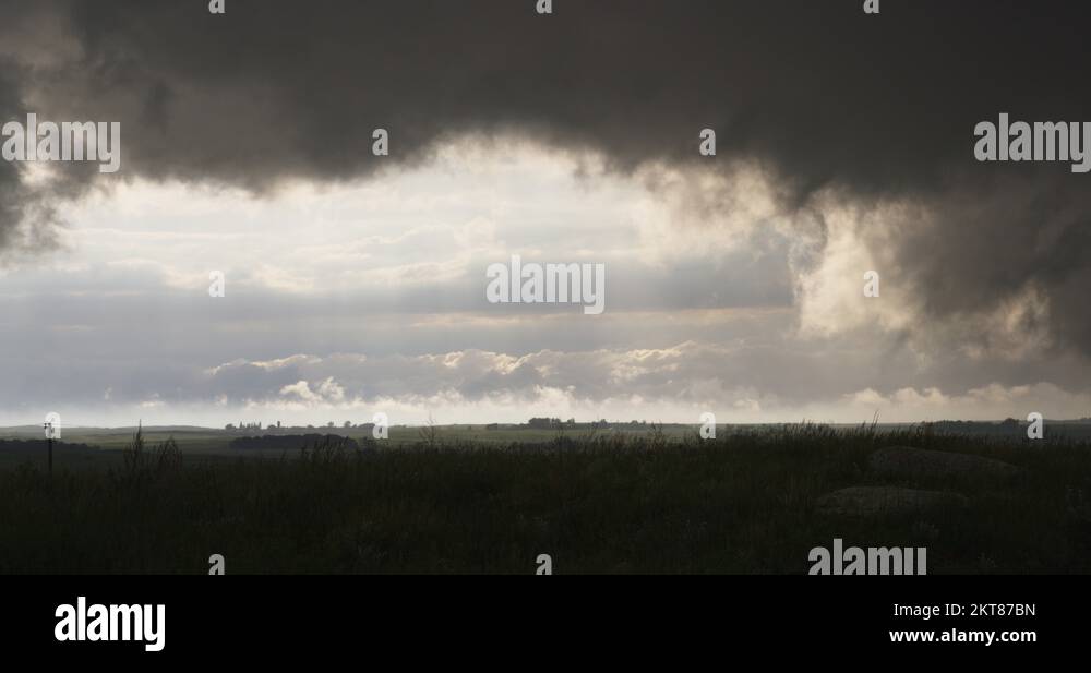 Black clouds overhead frame a sky full of lighter clouds in background ...