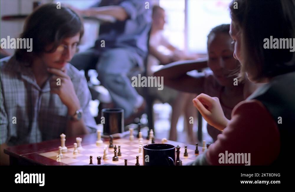 Close-up of young man and woman playing chess in a coffee house Stock ...