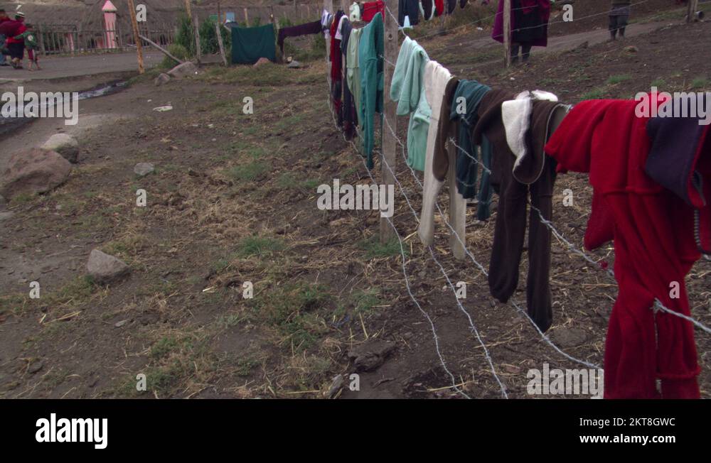 Ecuadorean woman hanging laundry on barbed wire fence Stock Video Footage - Alamy