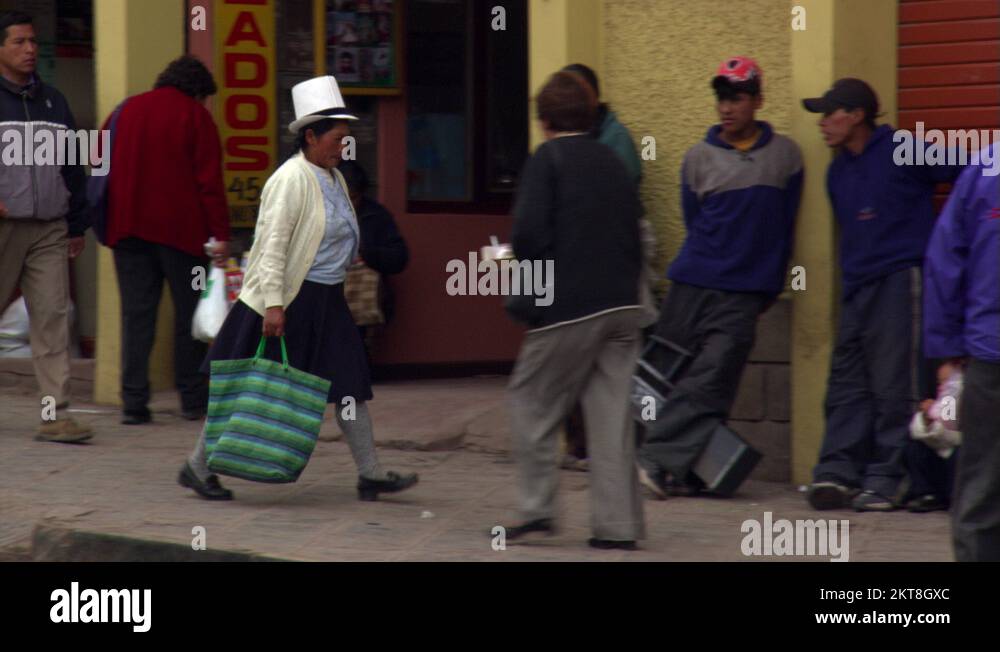Woman in white hat hurrying along a street in Cusco, Peru Stock Video ...