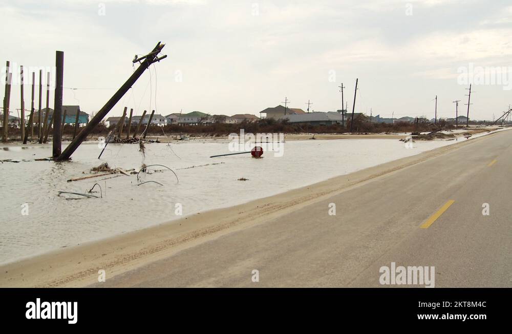 Zoom-in to toppled stop sign beside flooded road after a hurricane ...