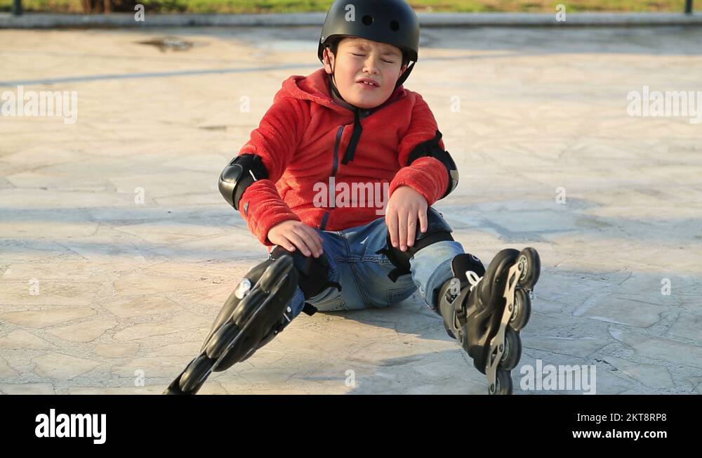 Injured young boy falling off skate, sitting on the floor Stock Video ...