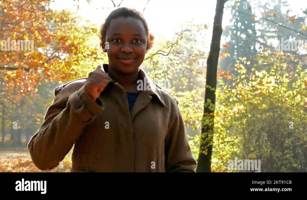 Young beautiful happy african girl stare into camera, shows the thumbs ...