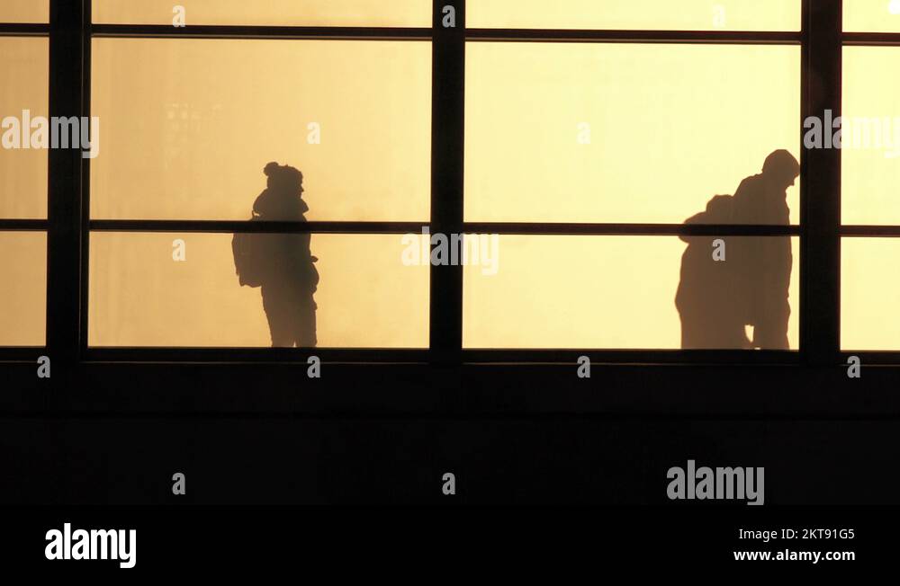 Silhouettes of unrecognizable people walking on street, pedestrians on ...