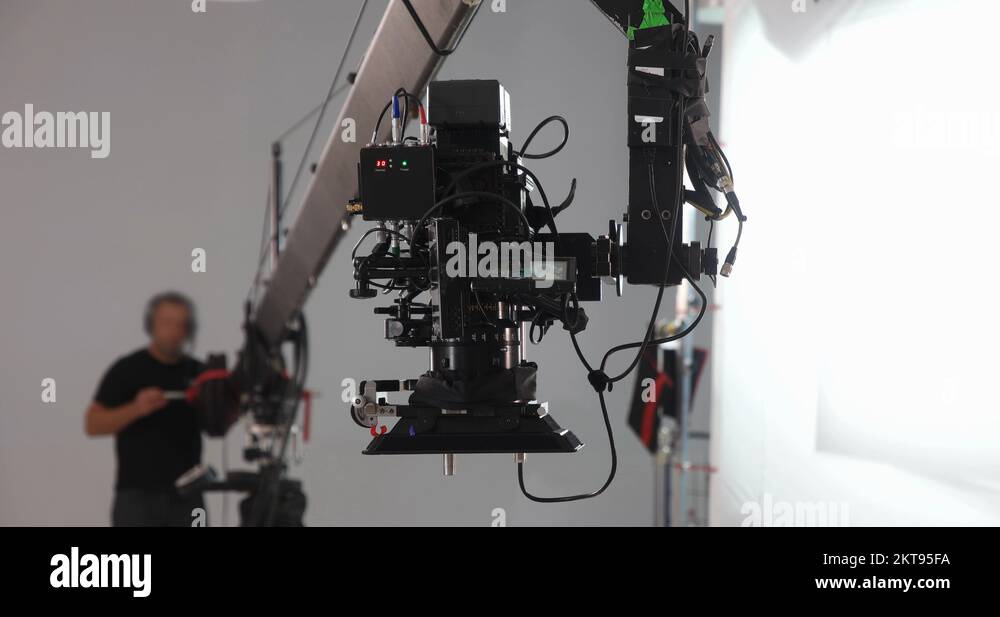 Camera jib operator moving Red Dragon upwards on professional ...