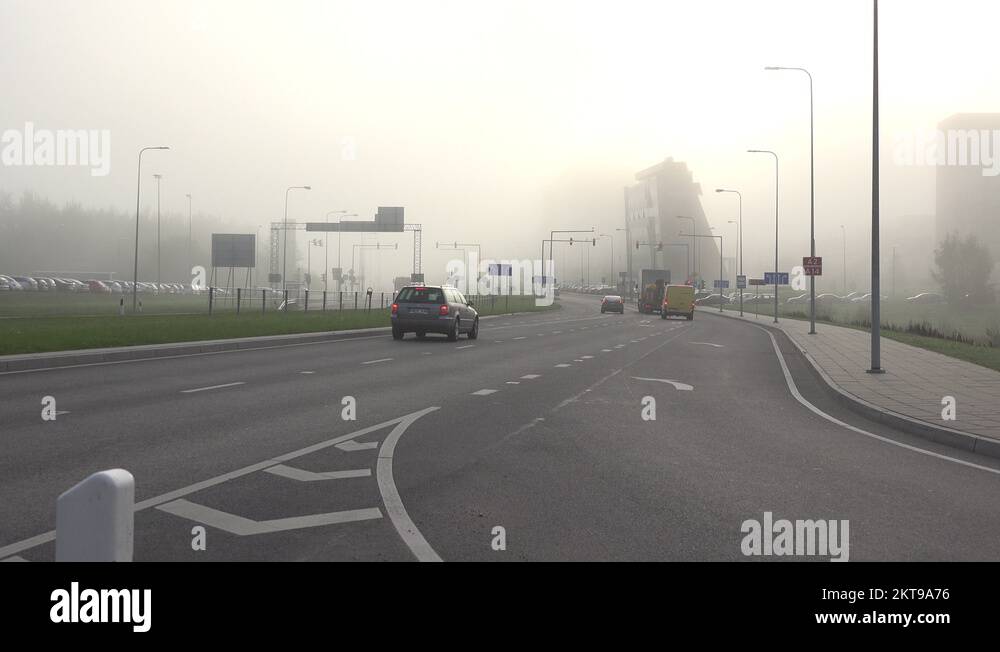 Cars drive through city crossroad with traffic lights in rush hour. 4K ...