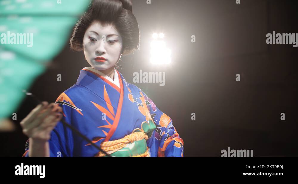 4K beautiful Japanese geisha dancing on stage and posing for the camera ...