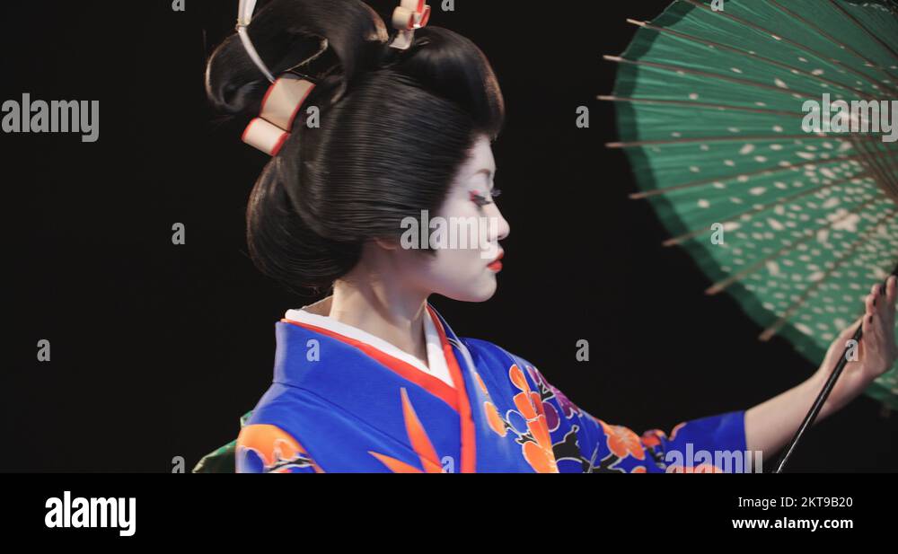 4K beautiful Japanese geisha dancing on stage and posing for the camera ...