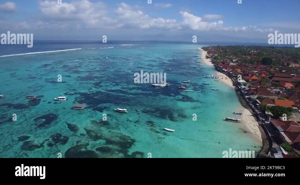 CINEMATIC 4K AERIAL OF SCENIC BLUE OCEAN, BEACH, BOATS AND HOUSES Stock ...