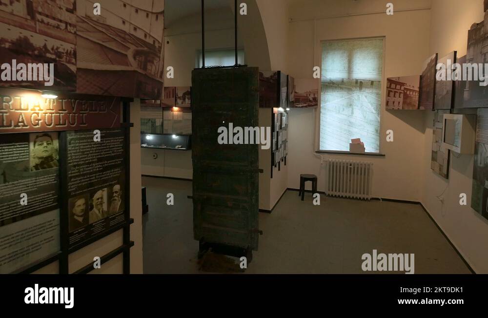 Room with pictures and an old prison cell door at Sighet Memorial ...
