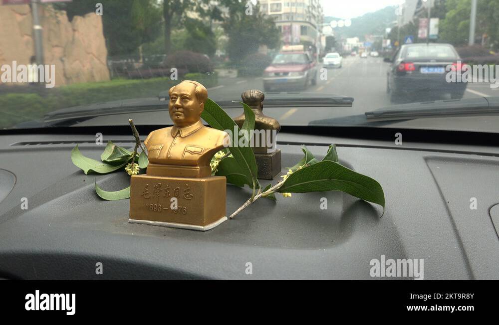 China, Mao Zedong statue in taxi car, driving through Shaoshan, his ...