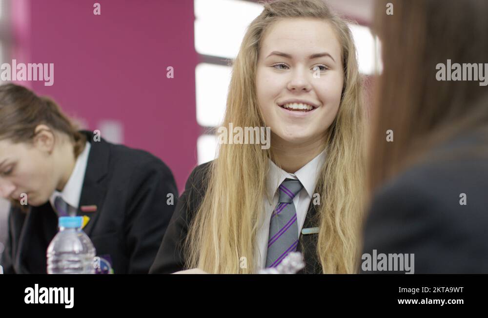 4K Happy teen girls talking during lunch break in school cafeteria ...