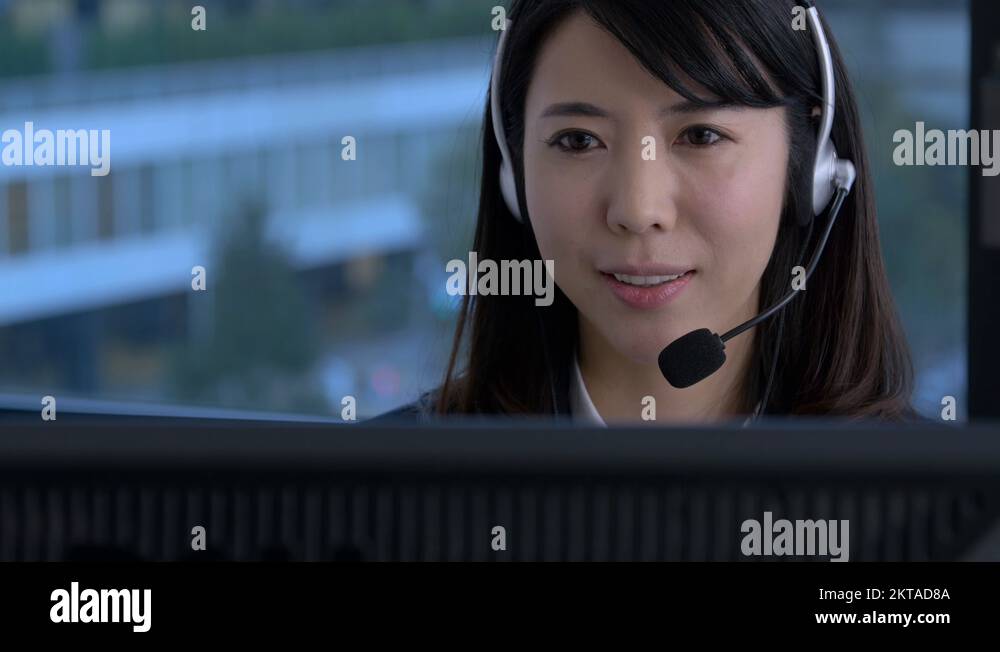 Young Japanese woman working at a call center in a modern office Stock ...