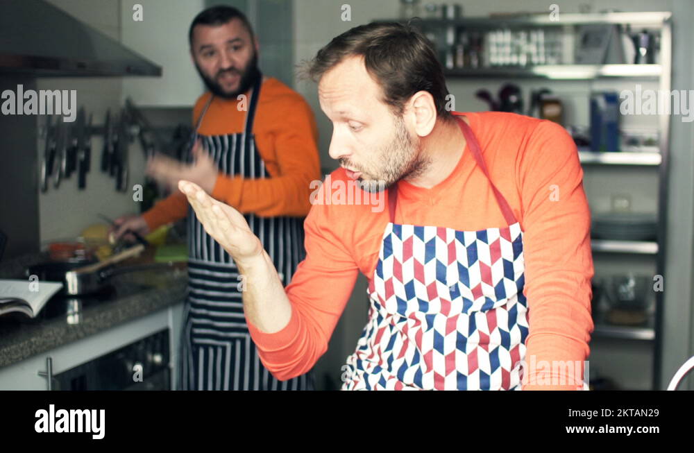 Two male friends fighting, arguing while cooking in kitchen Stock Video ...