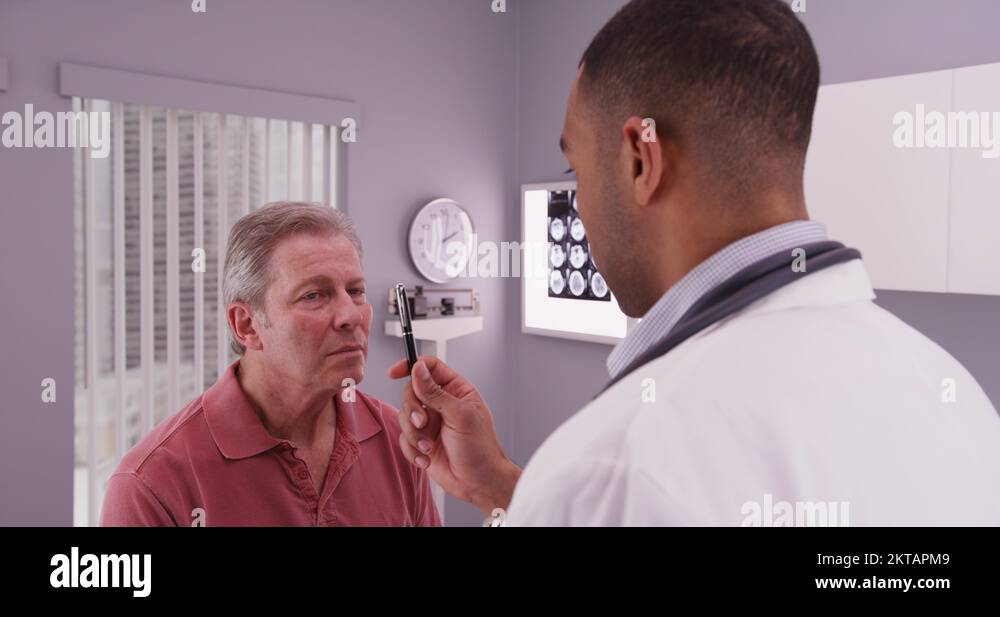 Elderly male patient with young doctor examining his concussion Stock ...