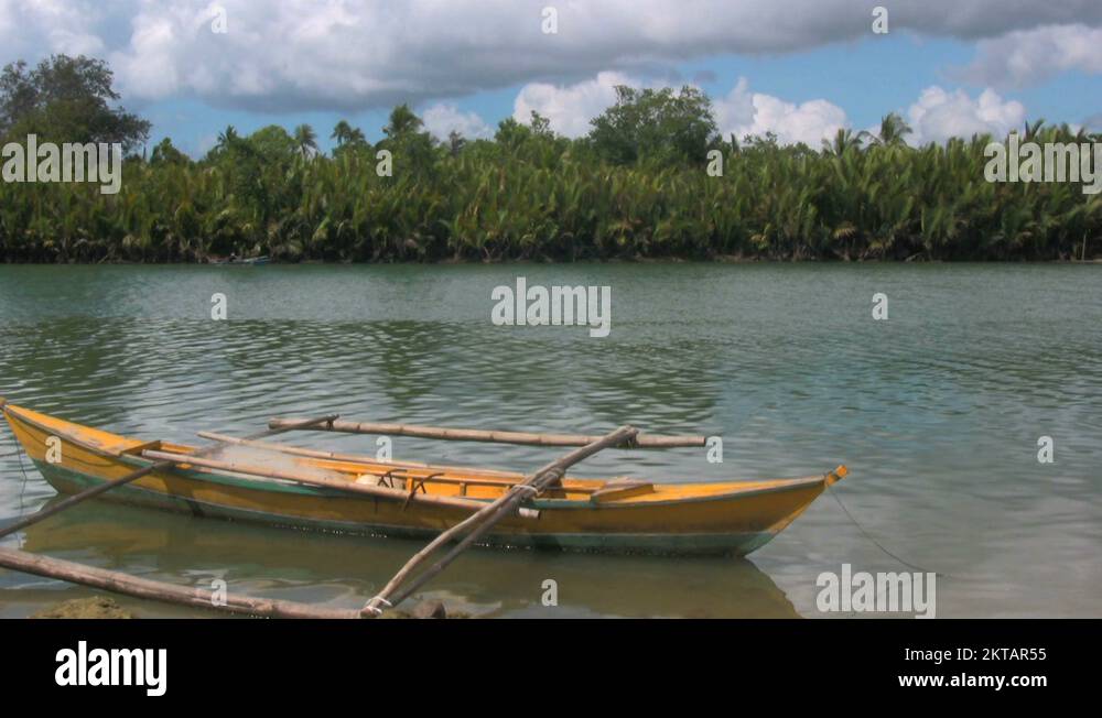 Traditional filipino banka outrigger boats on a river in Philippines ...