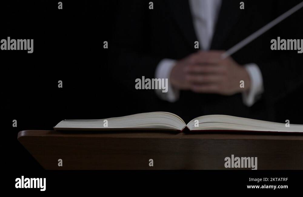 Conductor knocking on music desk with his baton Stock Video Footage - Alamy