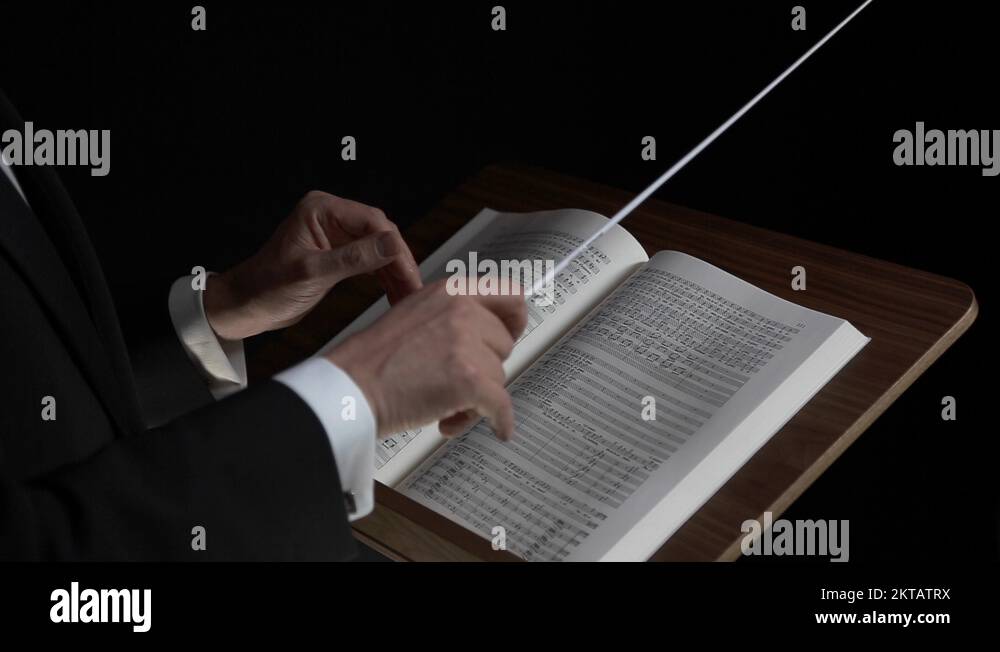 Conductor knocking on music desk with his baton Stock Video Footage - Alamy