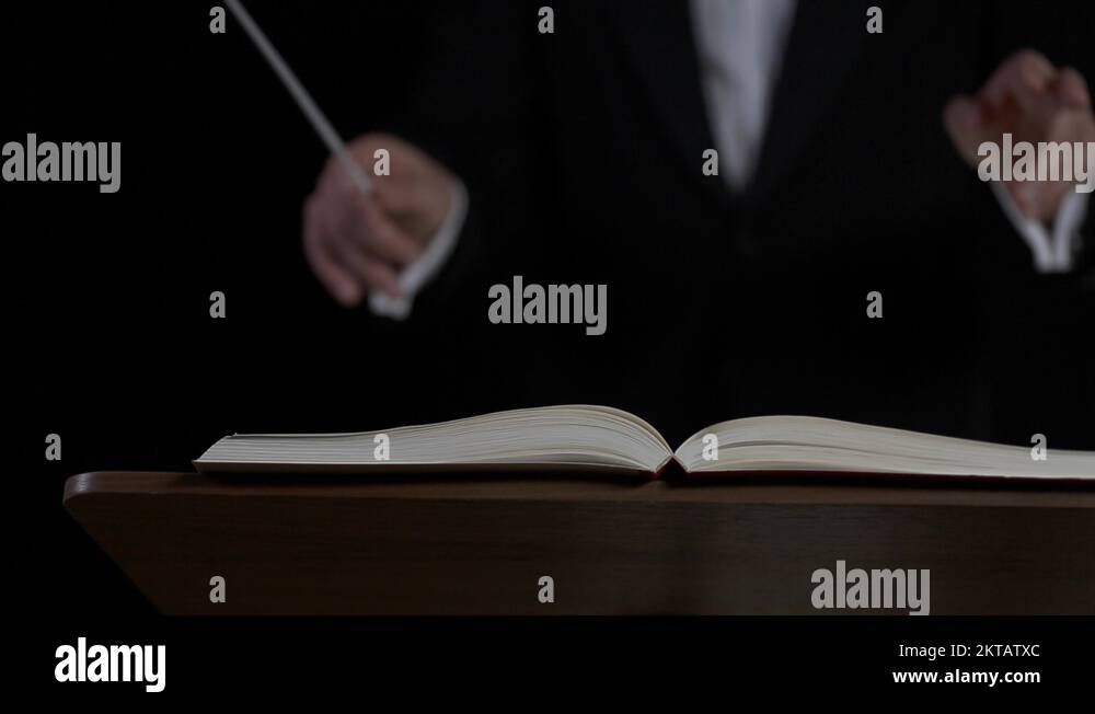 Conductor knocking on music desk with his baton Stock Video Footage - Alamy