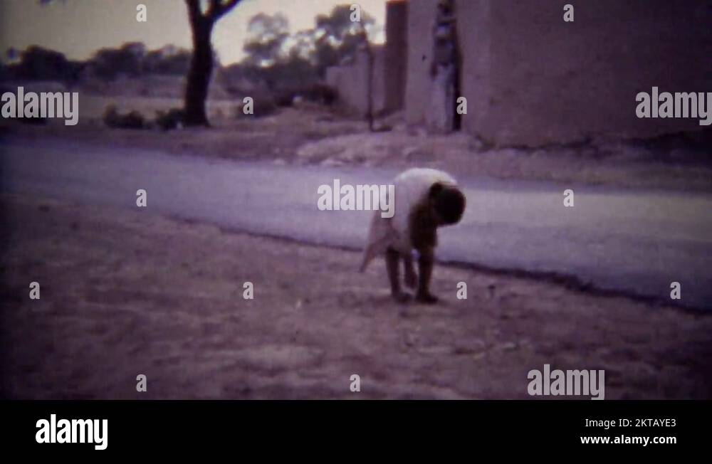 1973: Poor disabled arab kid roams rural middle eastern road Stock ...
