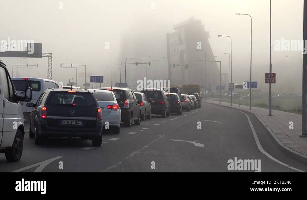 Traffic jam cars standing against green traffic lights in urban scene ...