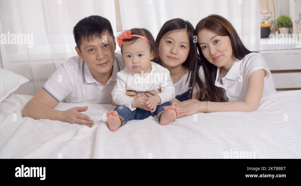 family idyll,a young Asian family with two daughters,family portrait ...
