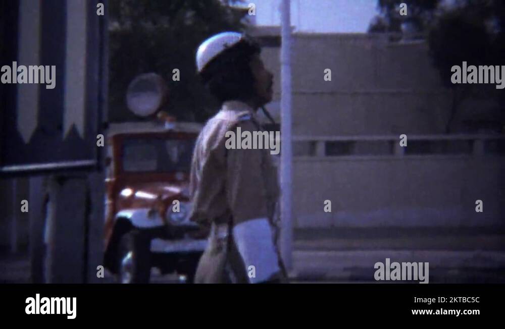 1974: Police uniform traffic officer patrolling busy street corner ...