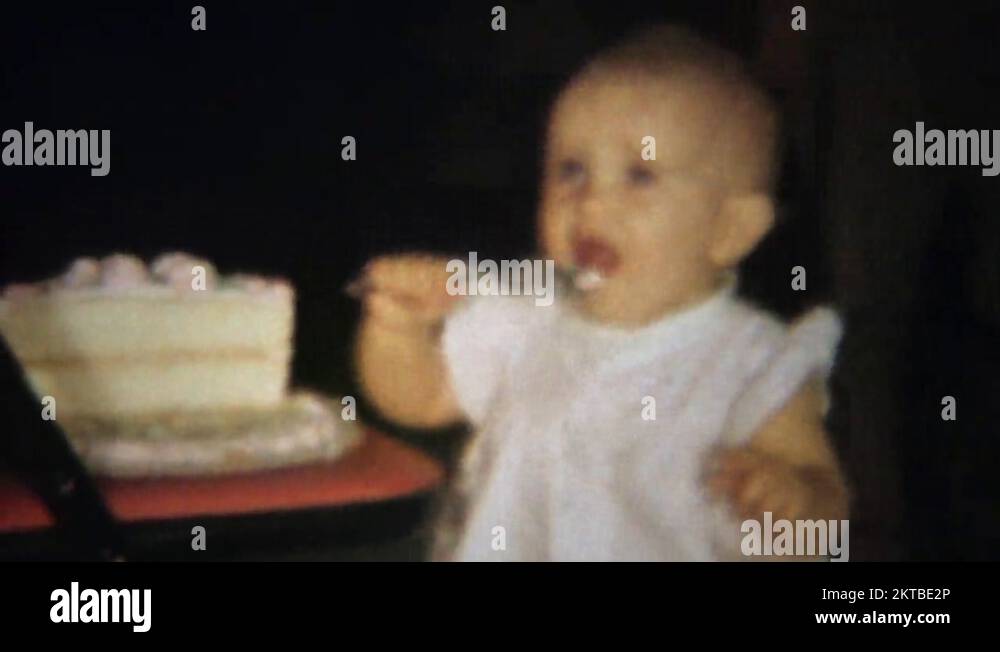 1963: Blonde baby girl eating half birthday cake with spoon Stock Video ...