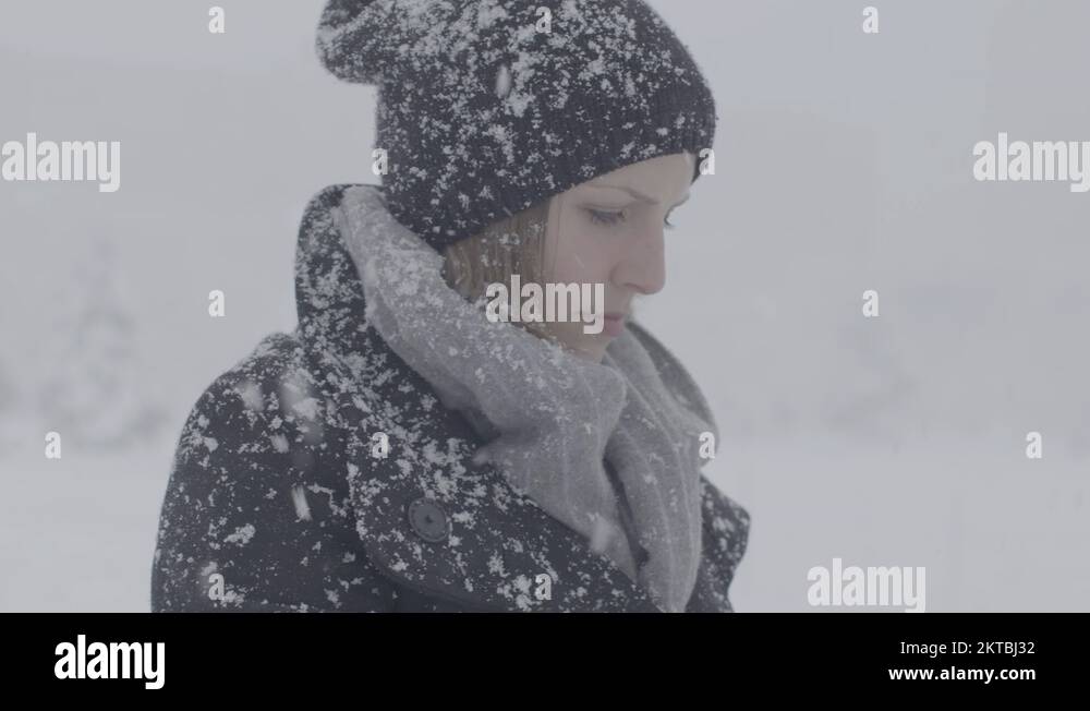 Girl standing in a blizzard Stock Video Footage - Alamy