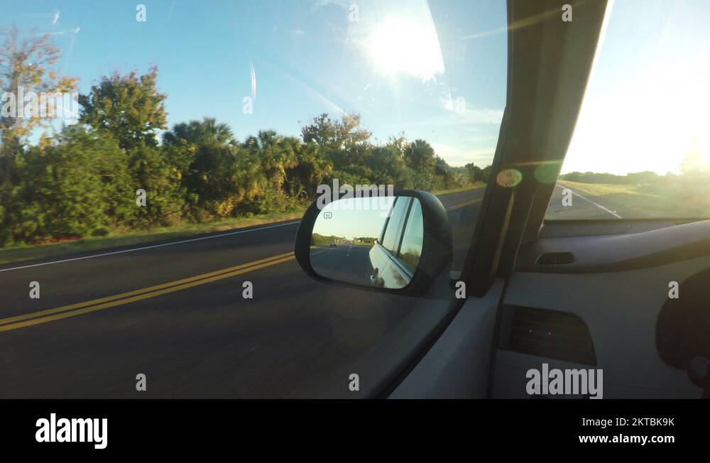 Driving in Car Looking out Rearview Mirror with Sun Flare, 4K Stock ...