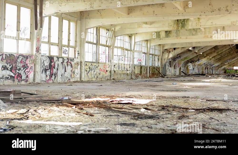 large dirty room with low ceiling - messy - wooden window frame ...