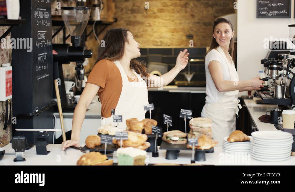 4K Portrait of friendly smiling workers standing behind counter in ...