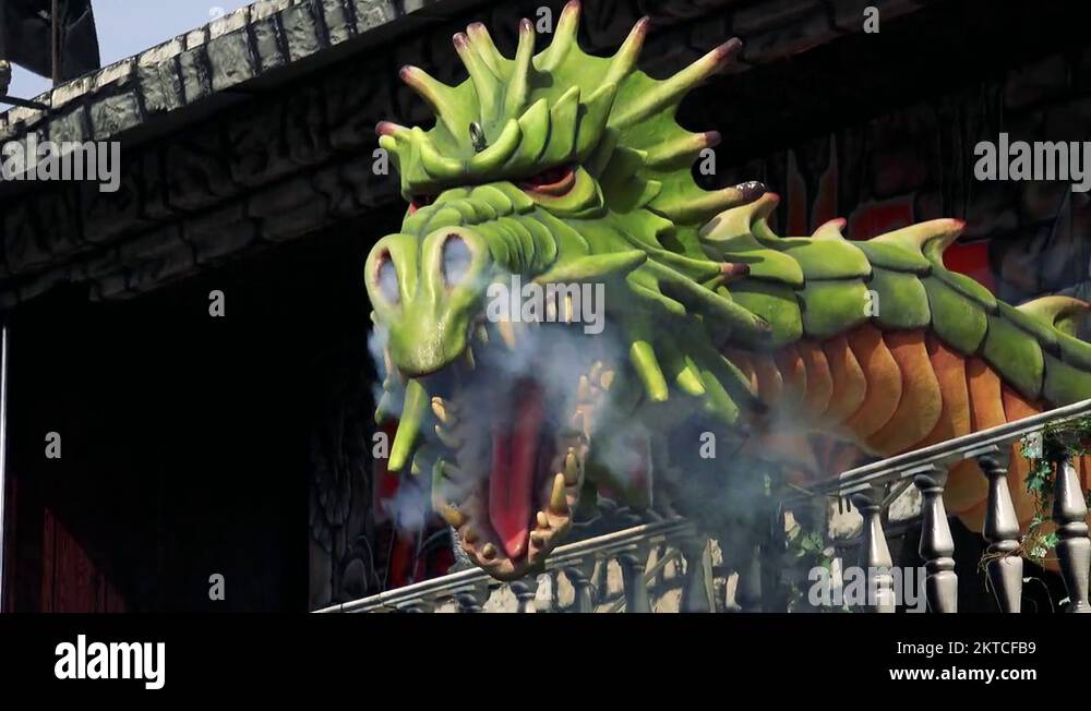Scary green dragon which deflate steam and visitors in runabout observe ...