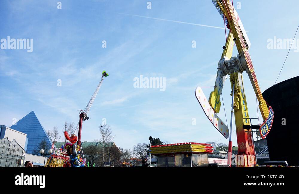Big attraction turns around with people in seats in funfair Stock Video ...