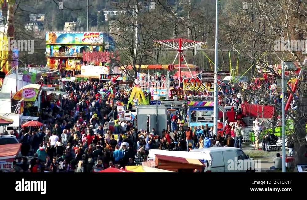 Crowd people in funfair with attraction and stands Stock Video Footage ...