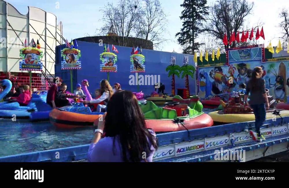 People sit in inflatable seats and sail on water in funfair Stock Video ...