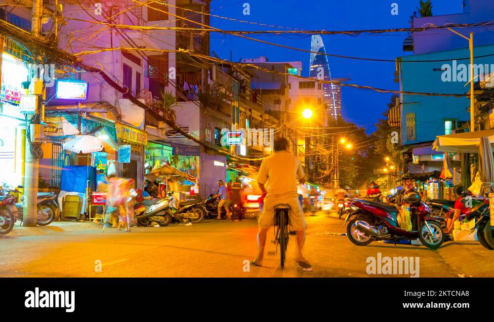 Vertical panning view of the busy night street in Ho Chi Minh City ...