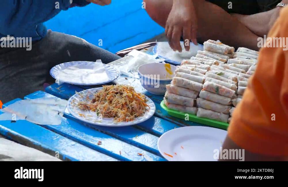 making a traditional vietnamese food - banh cuon. Closeup view of hands ...