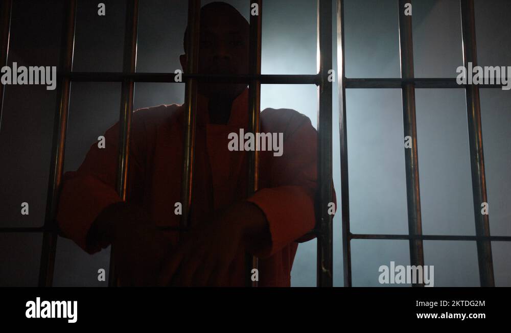 Ominous silhouette of inmate in prison cell - Jailed criminal Stock ...
