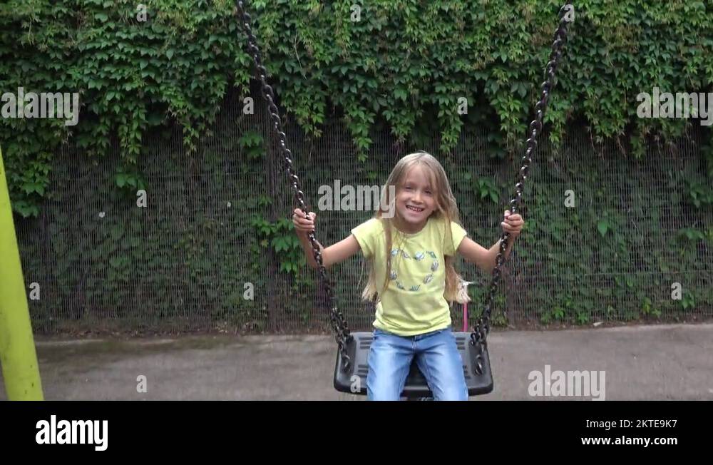 4K Happy Smiley Child Swinging, Little Girl Playing at Playground Park ...