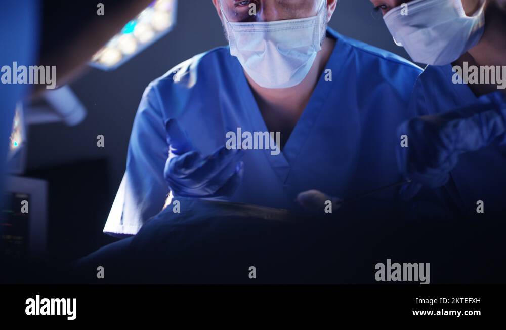 4K Team of surgeons in operating room, doctor gives injection to ...
