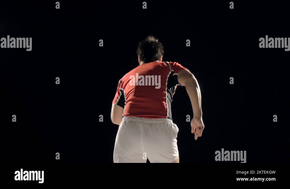 Slow motion footage of Japanese rugby player running with ball against ...