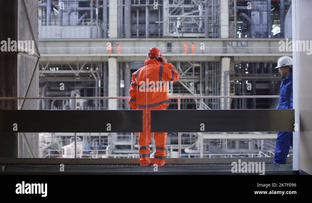 4K Team of workers at power plant, walking around the site & conducting ...