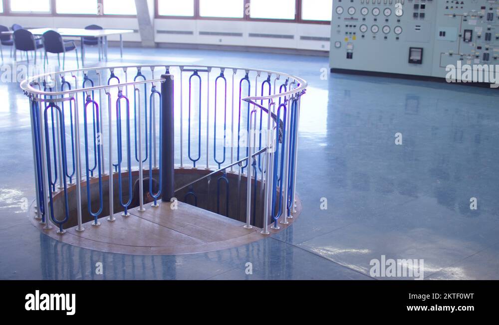 4KWorkers in power plant control room looking at control panel ...