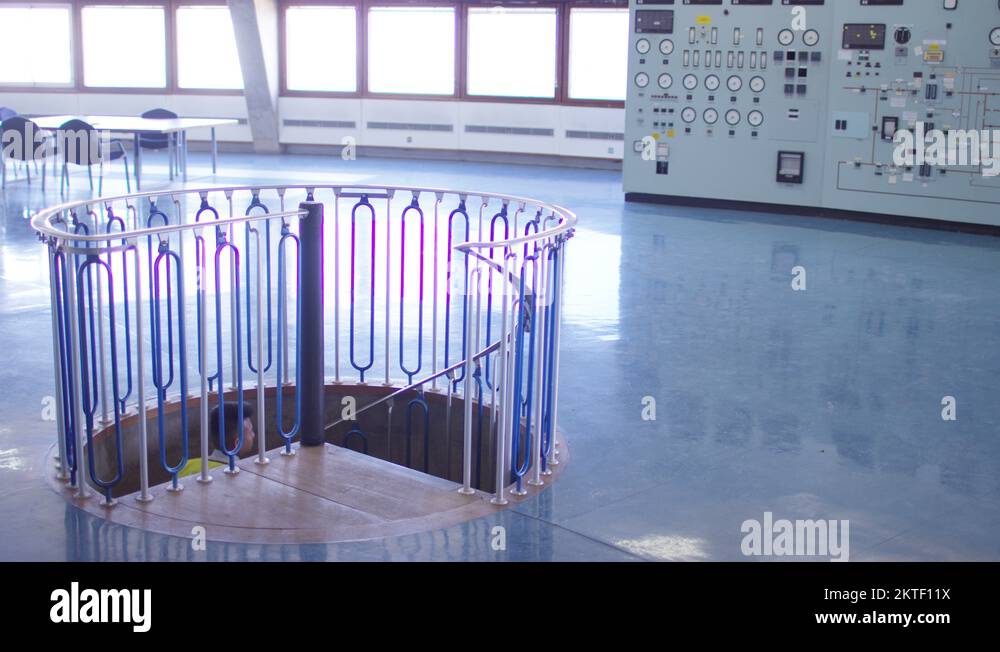 4KWorkers in power plant control room looking at control panel ...