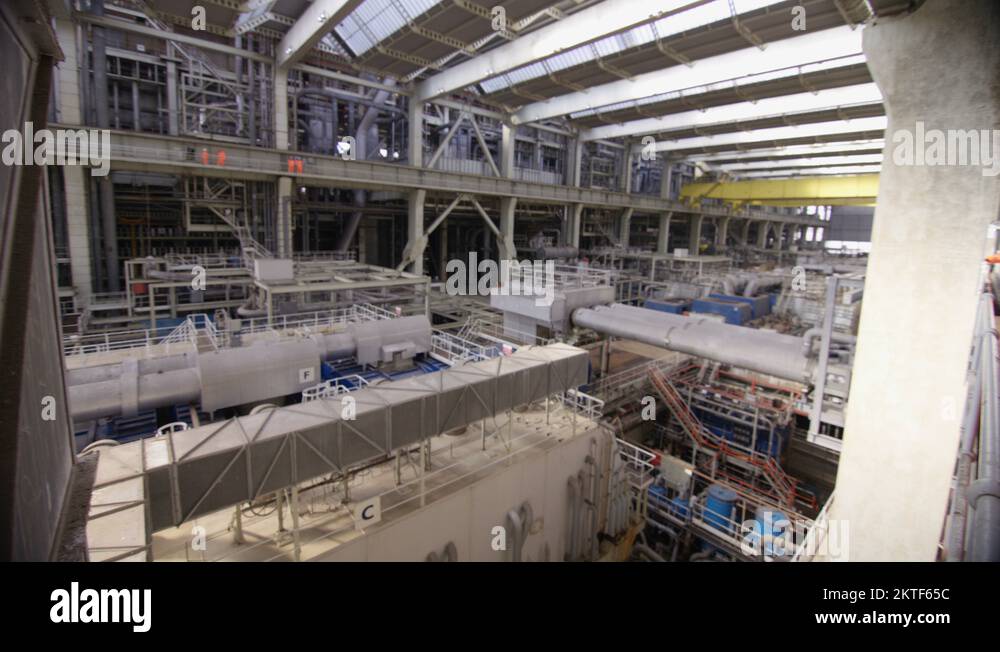 4K Interior view of huge industrial power plant & male & female ...