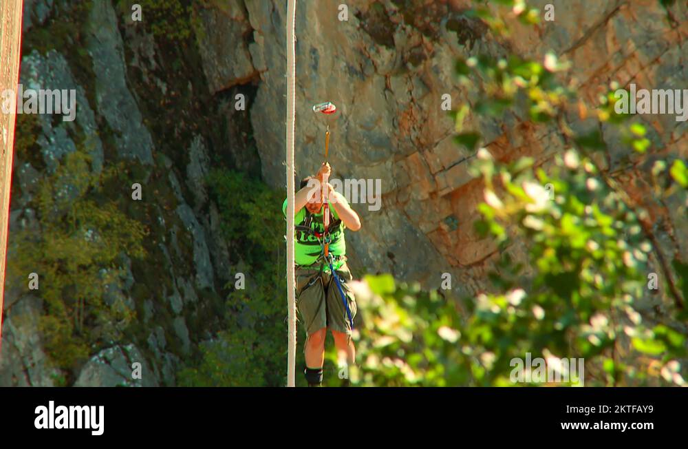 Bungee Jumping. The man hanging on the rope while pulling upward Stock ...